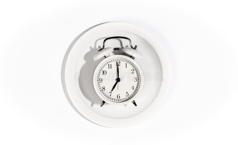 White Alarm Clock and Green Book in a White Bed, Top View. Stock Photo ...