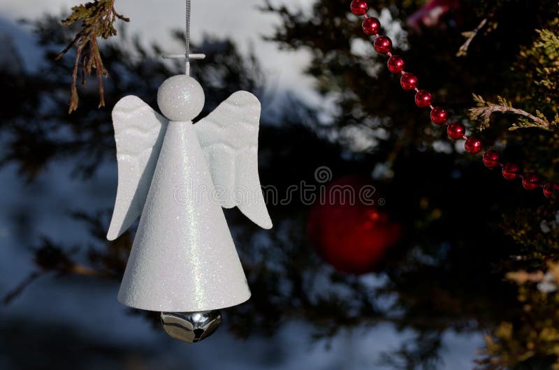 White Angel Christmas Ornament Decorating an Outdoor Tree Stock Photo ...