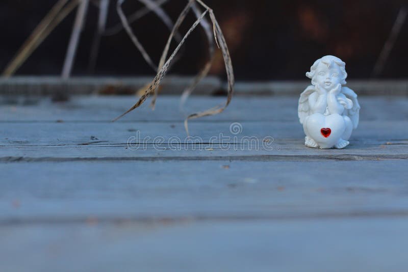 White angel sitting stock photo. Image of shore, sunset - 181460592