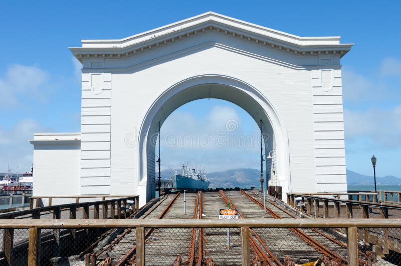 White Arch Structure on a Pier with Dual Railway Tracks, Marked by a ...