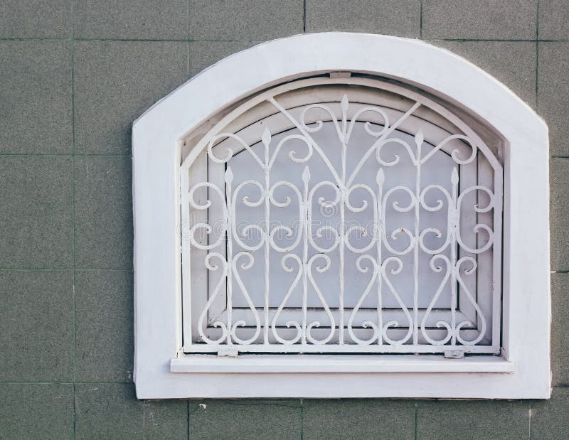 White Arched Window with Openwork Lattice on Gray Tiled Wall Stock ...
