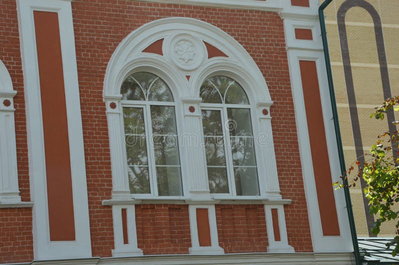 White Arched Windows Against Red Brick Walls. Building Facade Element ...