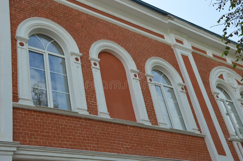 White Arched Windows Against Red Brick Walls. Part of the Building S ...