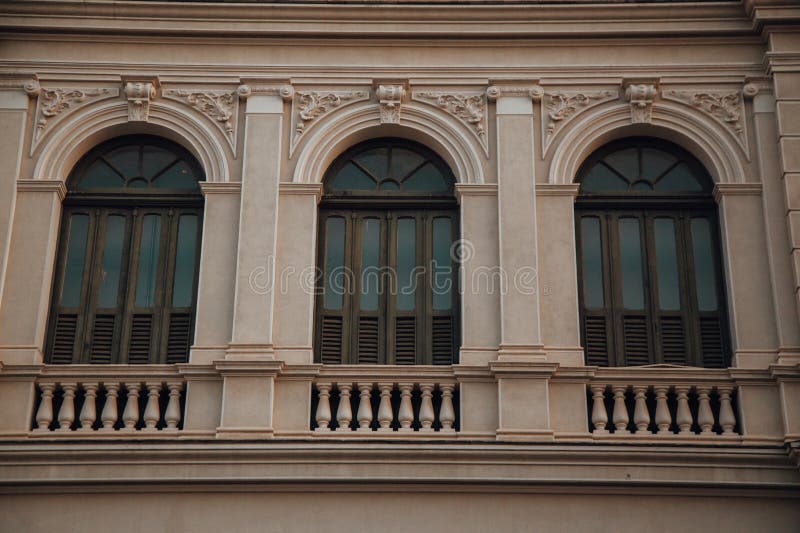 White Architectural Building Featuring Multiple Windows with Arch ...