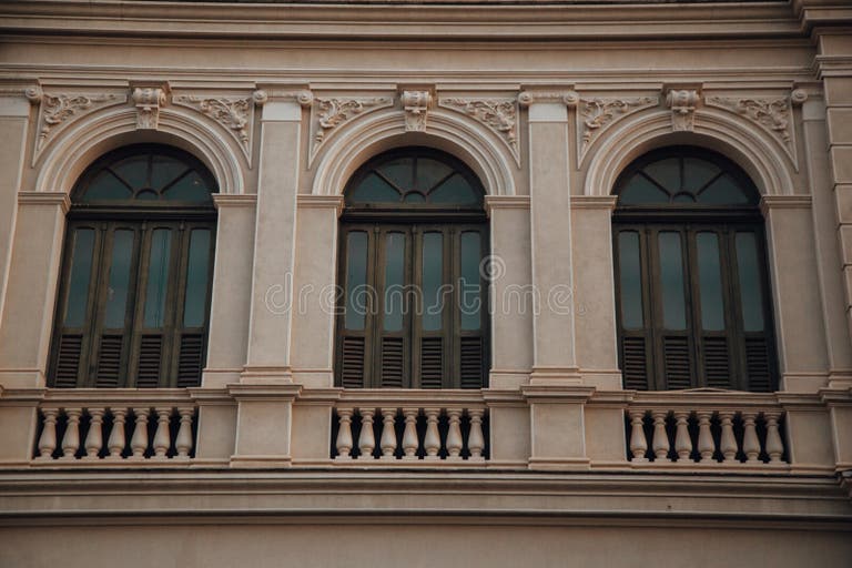 White Architectural Building Featuring Multiple Windows with Arch ...