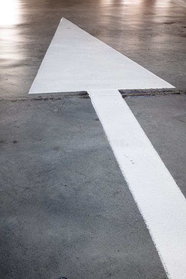 White Arrow Indicating the Direction of Entry or Exit on the Floor ...
