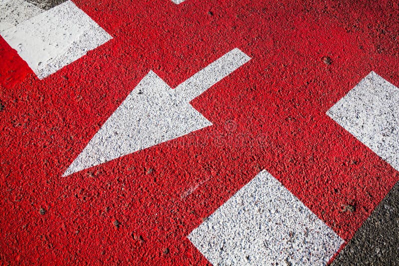 White Arrow on the Red Asphalt Surface Stock Image - Image of ...