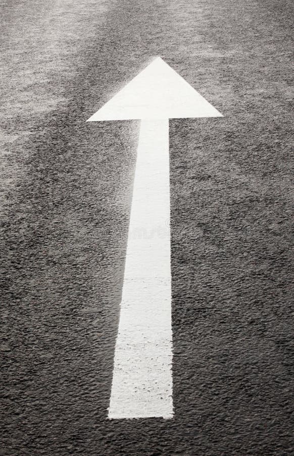White arrow on the road stock image. Image of directional - 183128223