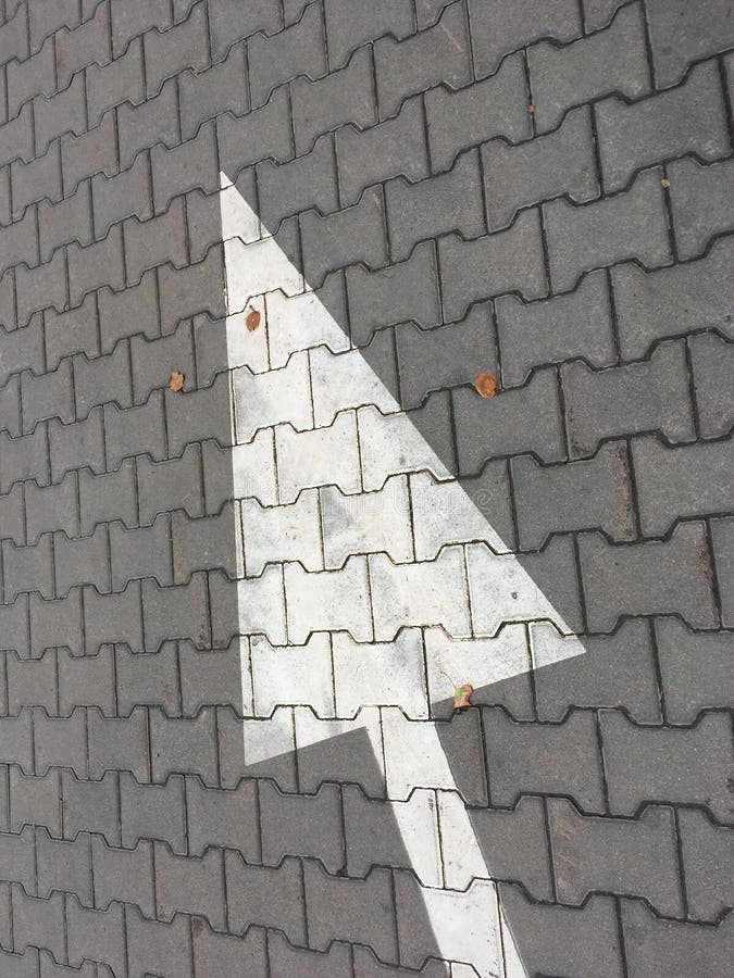White arrow on road tile stock photo. Image of europe - 193119664