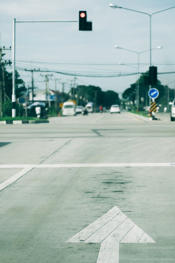 White Arrow Symbol on on Crossroad with Red Traffic Light Stock Image ...