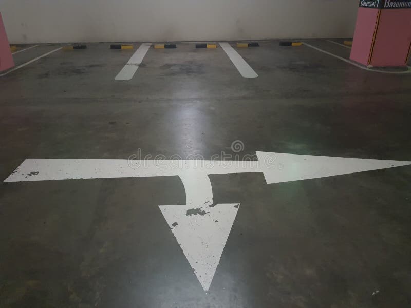 White Arrows Sign Painted on Empty Parking Lot Stock Image - Image of ...