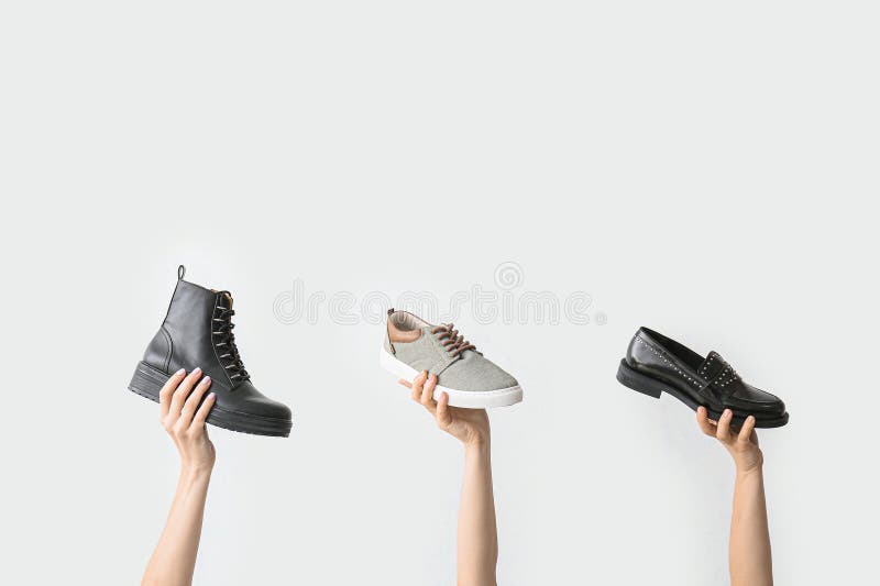 Hands with Stylish Shoes on White Background Stock Photo - Image of ...