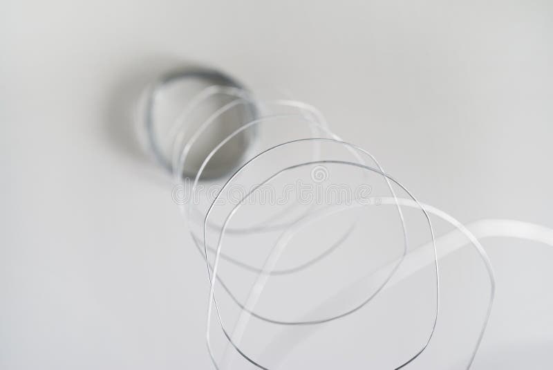 White Background Skein of Silver Wire. Pulling the End of the Wire, it ...
