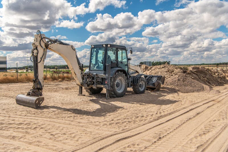 A White Backhoe at a Construction Site Stock Image - Image of develop ...