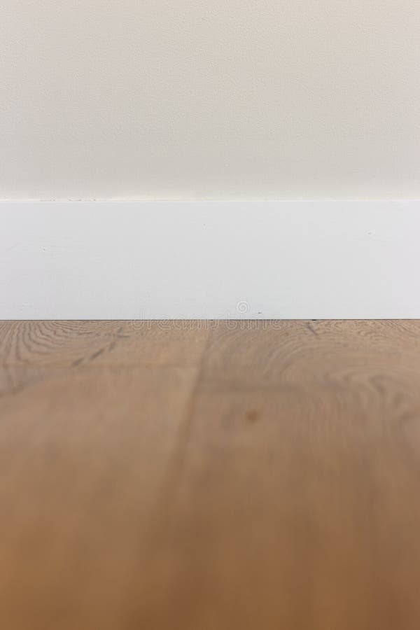 White Baseboard, White Wall and Wood Laminate. Stock Photo - Image of ...