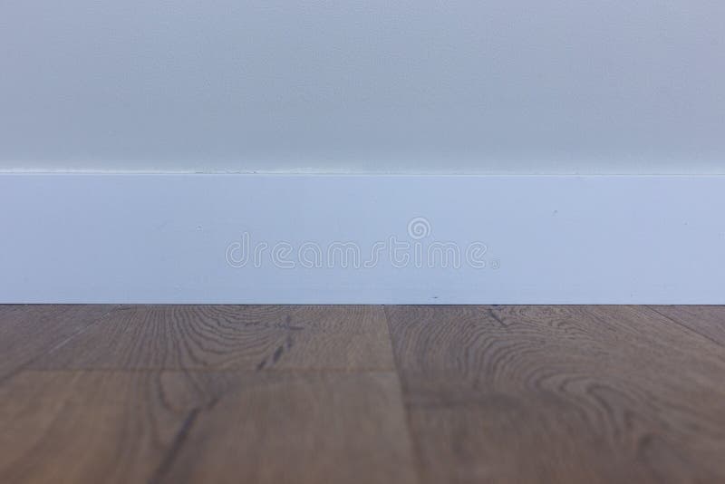 White Baseboard, White Wall and Wood Laminate. Stock Image - Image of ...