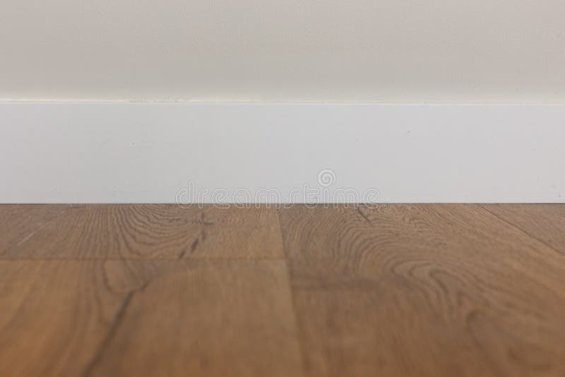 White Baseboard, White Wall and Wood Laminate. Stock Image - Image of ...