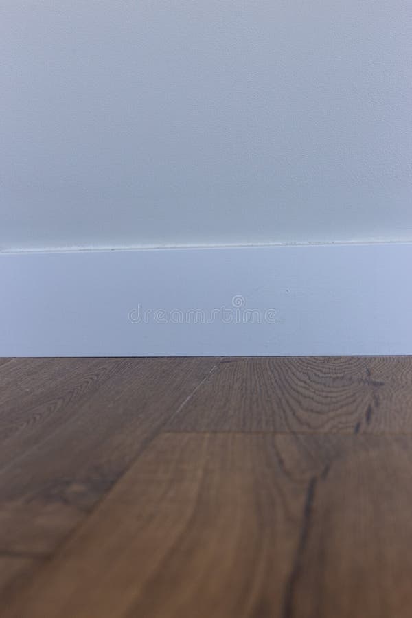 White Baseboard, White Wall and Wood Laminate. Stock Image - Image of ...