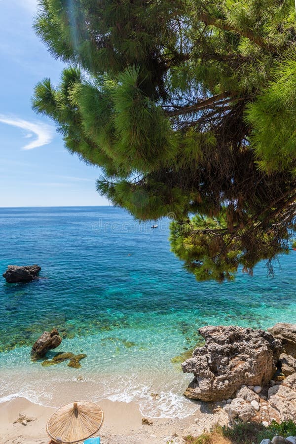 White Beach with Rocks in the Turquoise Clear Sea Stock Photo - Image ...