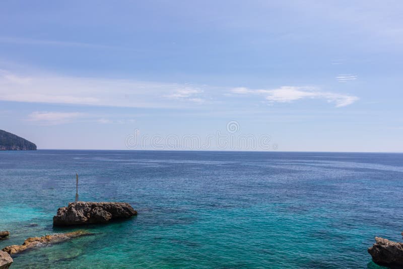 White Beach with Rocks in the Turquoise Clear Sea Stock Image - Image ...