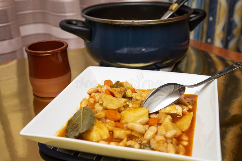 White Bean and Cod Stew in a Casserole and Served on a Plate with a ...