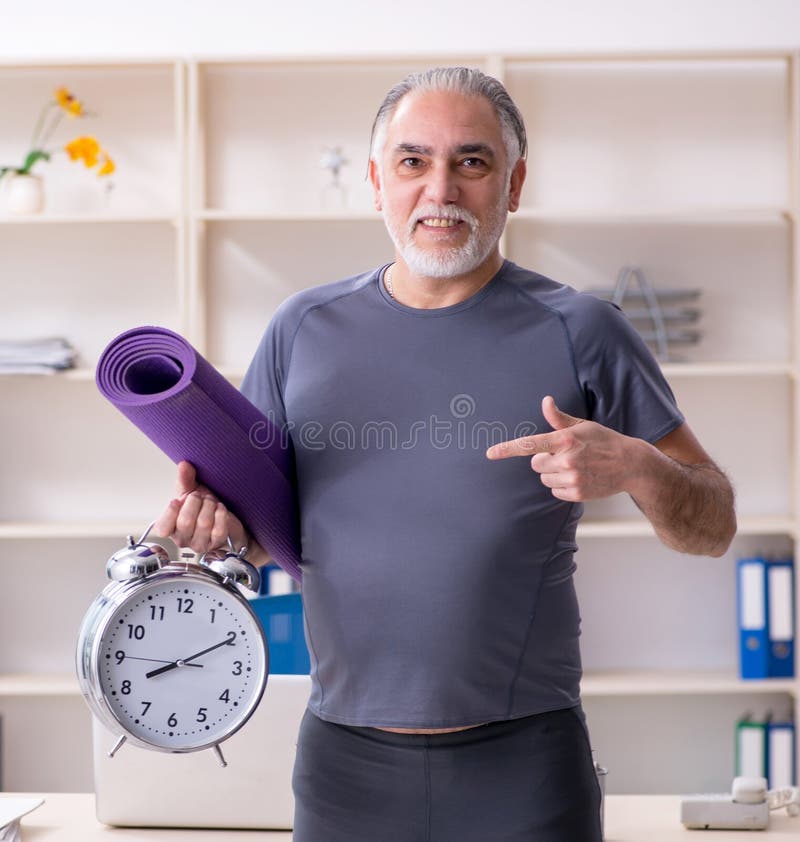 White Bearded Old Man Employee Doing Exercises in the Office Stock ...