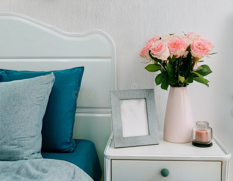 White Bedside Table Near the Bed Against a White Wall with Items Stock ...