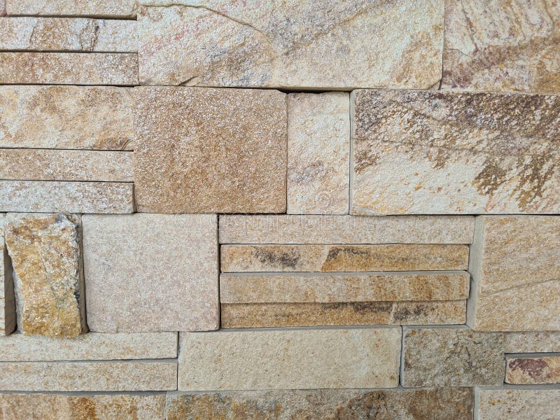 White and Beige Mix of Natural Stone Stacked Against Stone Wall Stock ...