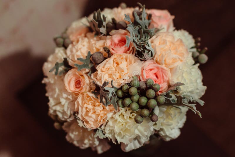 White and Beige Wedding Bouquet Decorated with Green Berries Stock ...