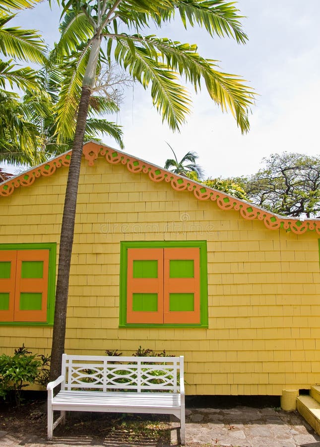 White Bench by Green and Yellow Building Stock Image - Image of bench ...
