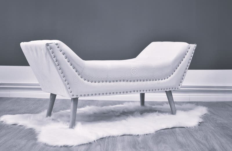 A White Bench on a White Rug Stands Indoors Stock Photo - Image of wall ...