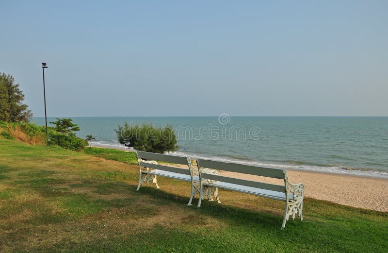 White Benches on the Beach in Front of the Sea Stock Photo - Image of ...