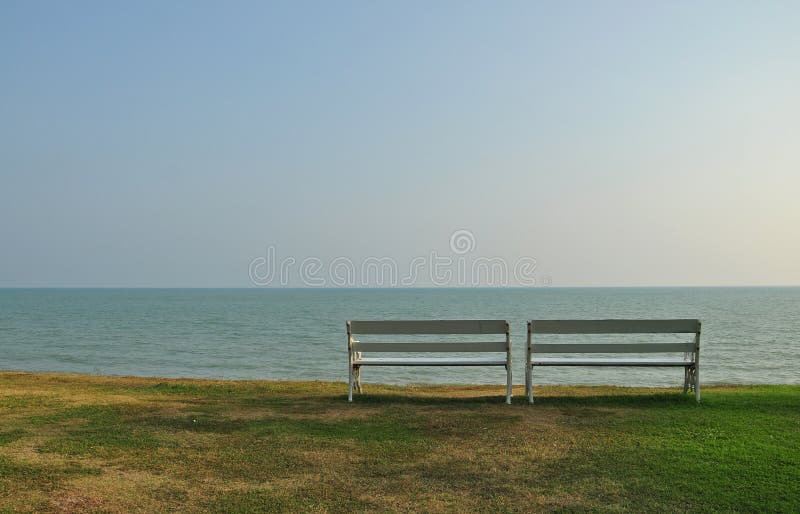 White Benches on the Beach in Front of the Sea Stock Photo - Image of ...