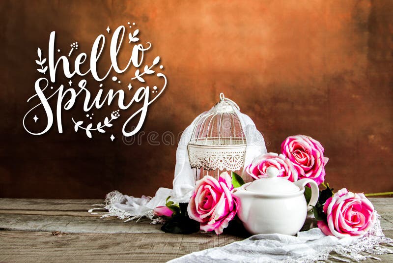 White Cage and a Tea Pot with Roses and Decoration with Text Hello ...