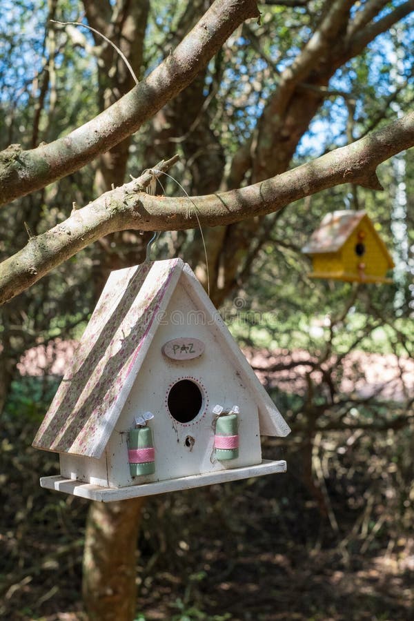 A White Birdhouse with a Pink Ribbon Hanging from it Stock Image ...