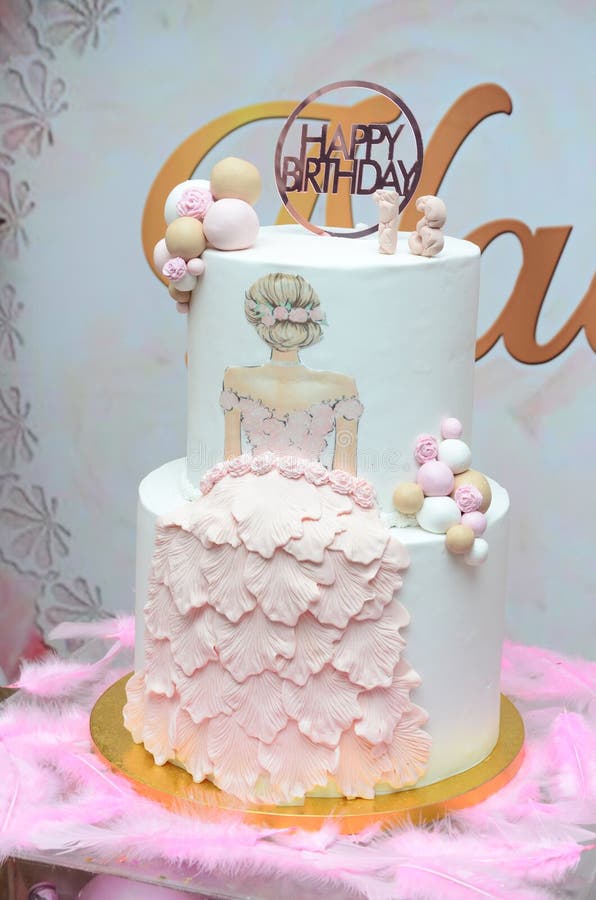 A White Birthday Cake with a Bride in a Pink Dress on the Cake Stock ...