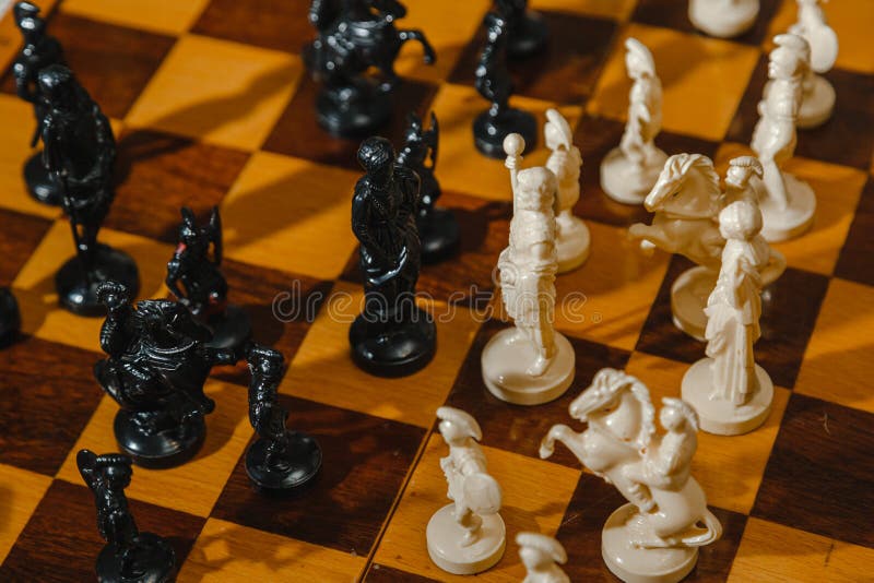 White and Black Chess Pieces Stand on the Board during a Chess Game ...