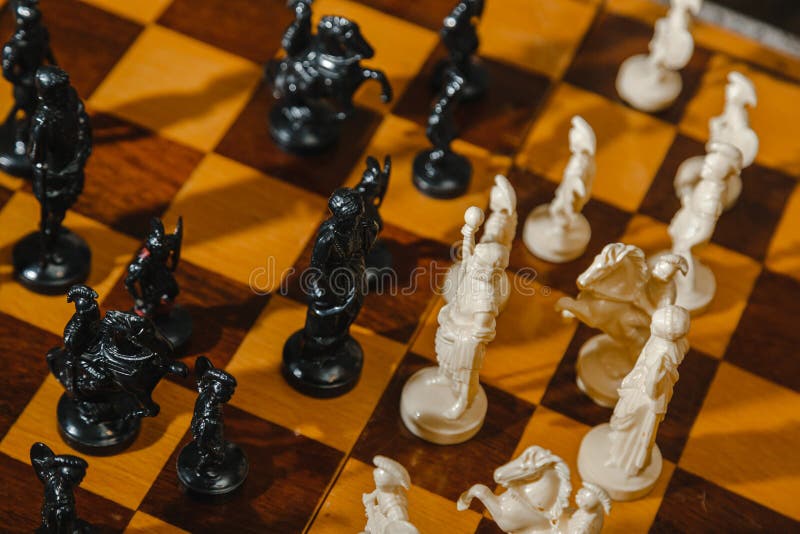 White and Black Chess Pieces Stand on the Board during a Chess Game ...