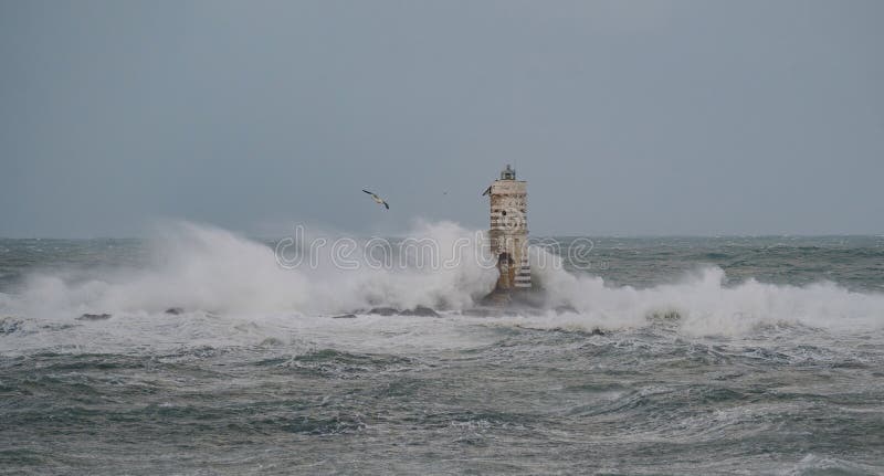White and Black Lighthouse Standing in Rough Sea during Storm Stock ...