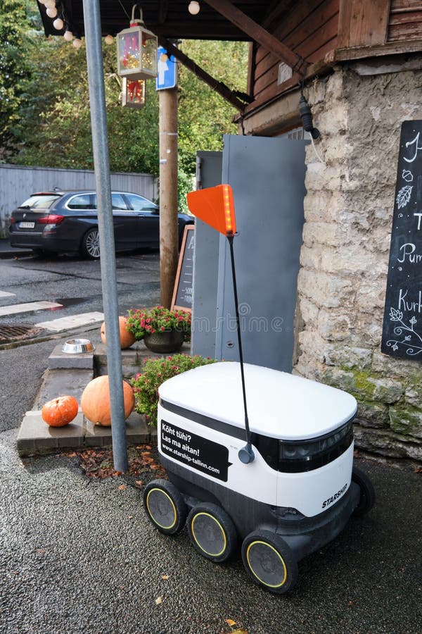 A White and Black Robot Sitting on the Side of a Road Editorial ...