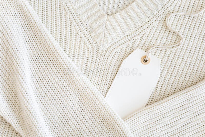 White Blank Label on a Background of White Knitted Clothing. Stock ...
