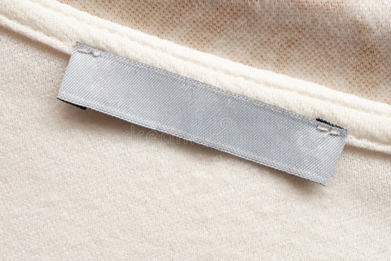 White Blank Laundry Care Cloth Label on Fabric Texture Background Stock ...