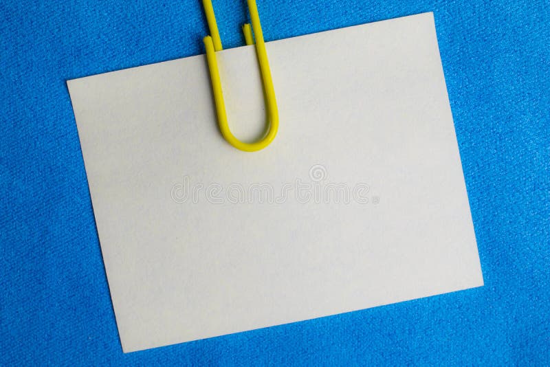 White Blank Note Pinned To a Blue Notice Board with a Paper Clip Stock ...