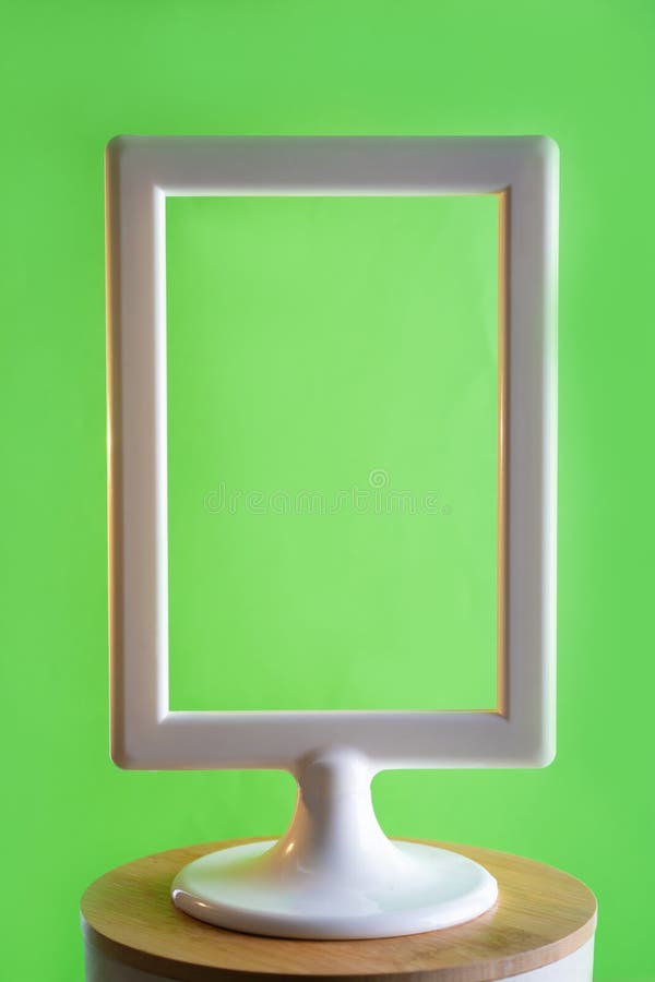 White Blank Photo Frame Stay on Stand on Green Background. Vertical ...