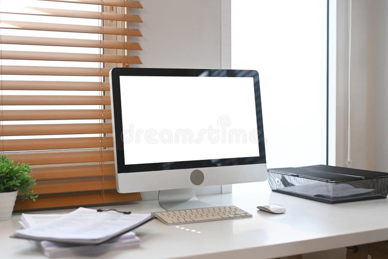 White Blank Screen Computer Monitor, Paperwork and Houseplant on ...