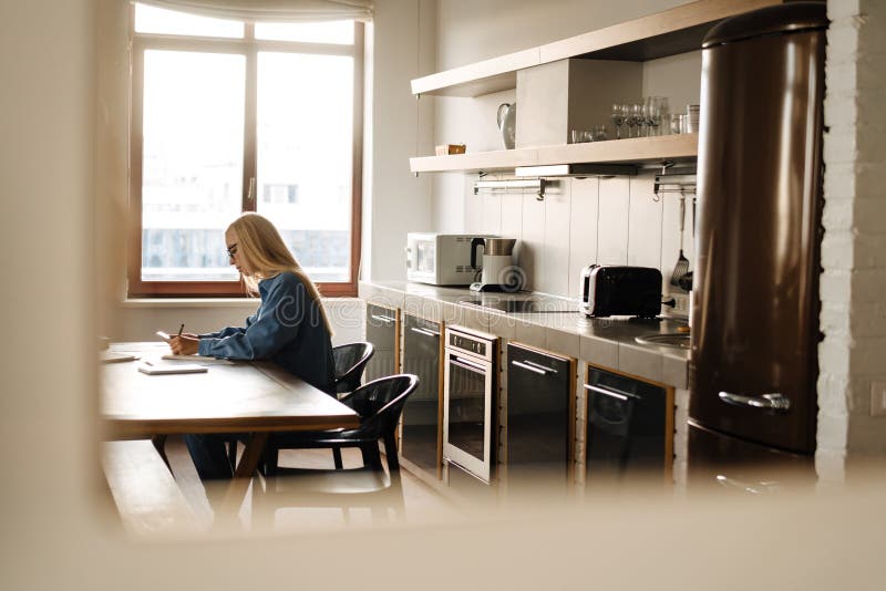 White Woman Using Mobile Phone while Working at Home Stock Image ...