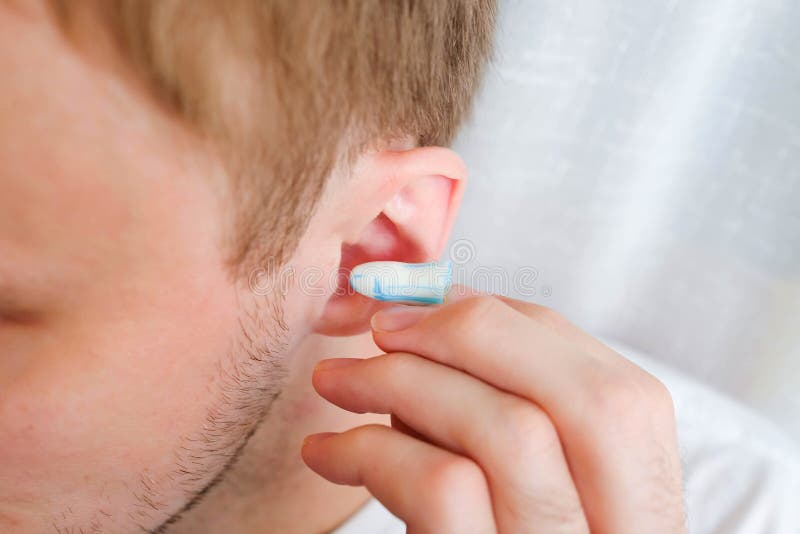 White and Blue Ear Plug Puts in the Ear Stock Photo - Image of ...