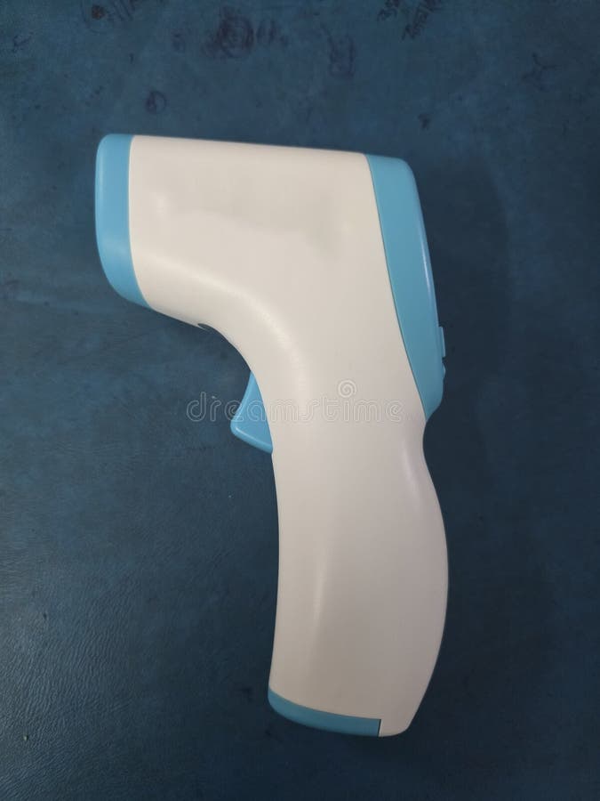 White and Blue Infrared Forehead Thermometer on Dark Background Stock ...