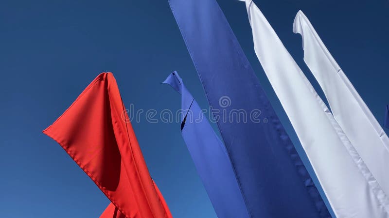 White, Blue and Red Flags Waving in the Wind, Blue Sky Stock Image ...