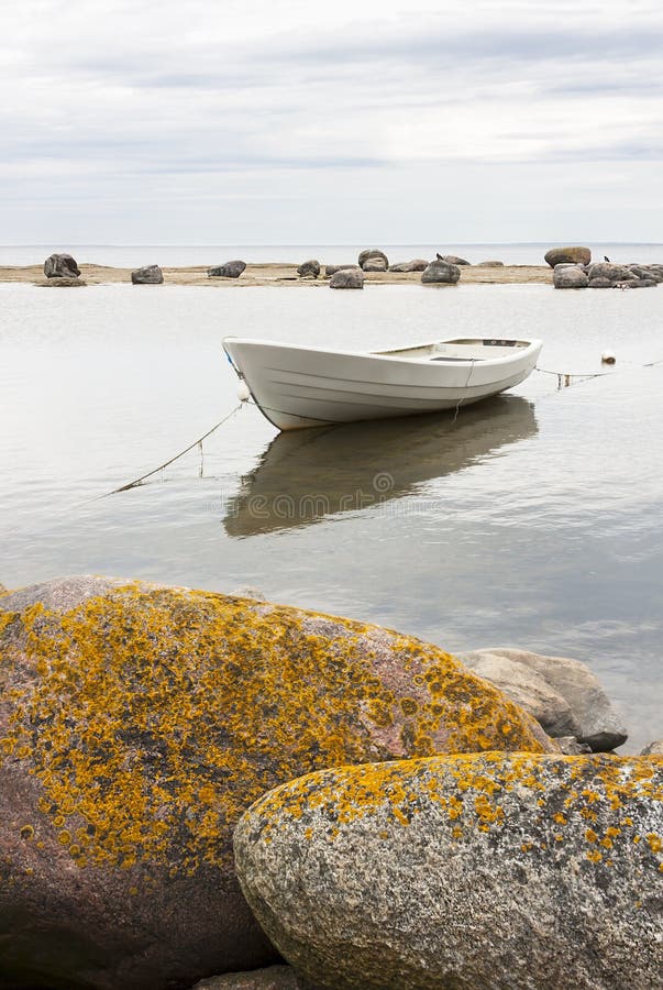 White boat behind rocks stock image. Image of transportation - 74558449